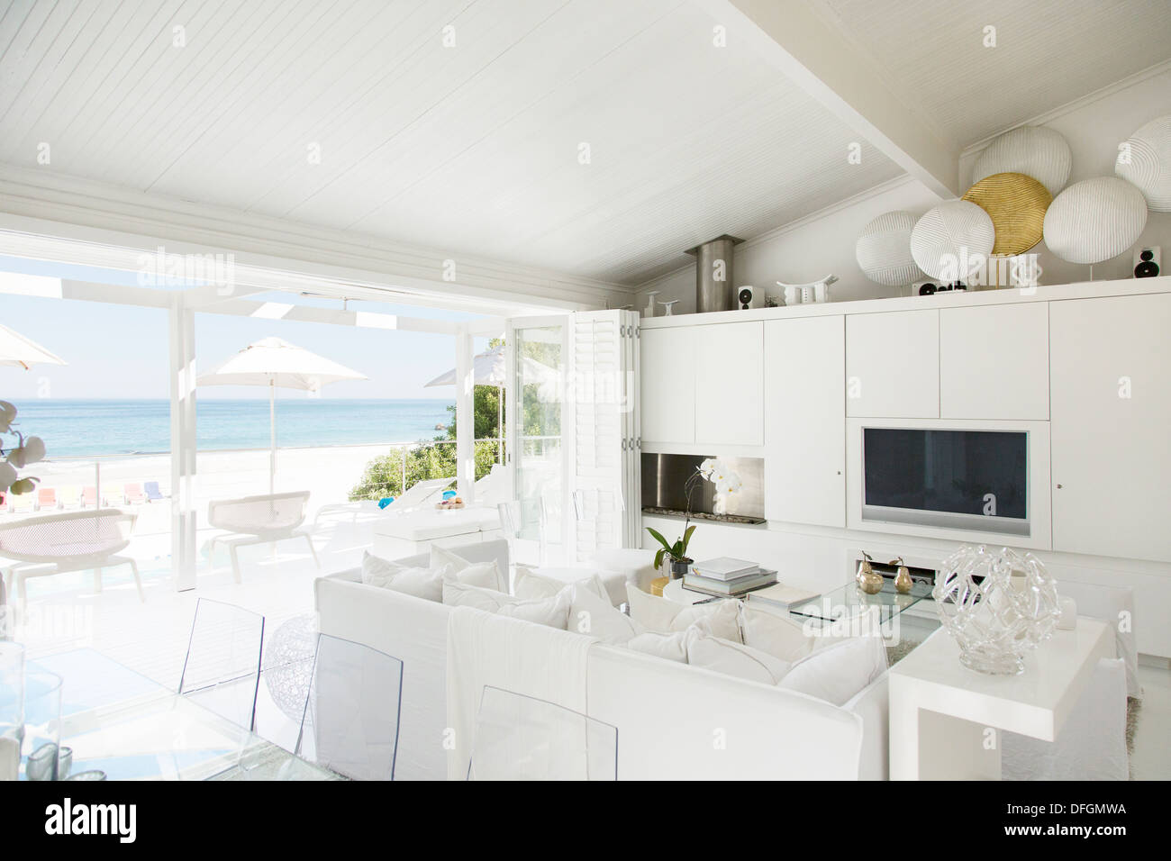 Modern living room overlooking beach and ocean Stock Photo - Alamy
