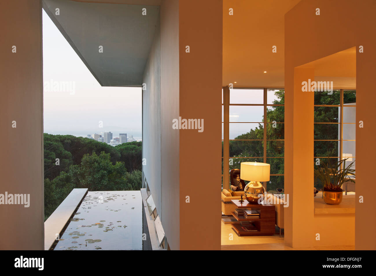 Modern house overlooking city in distance at sunset Stock Photo - Alamy