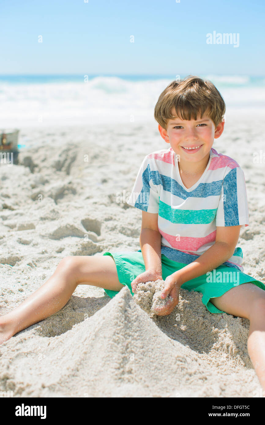 Boy building sandcastle on beach hi-res stock photography and images ...