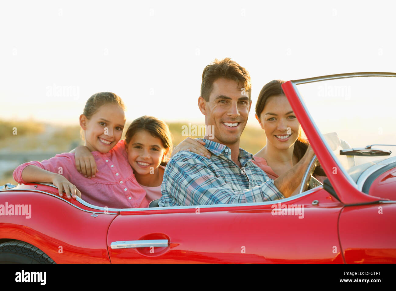 Family in convertible together Stock Photo - Alamy