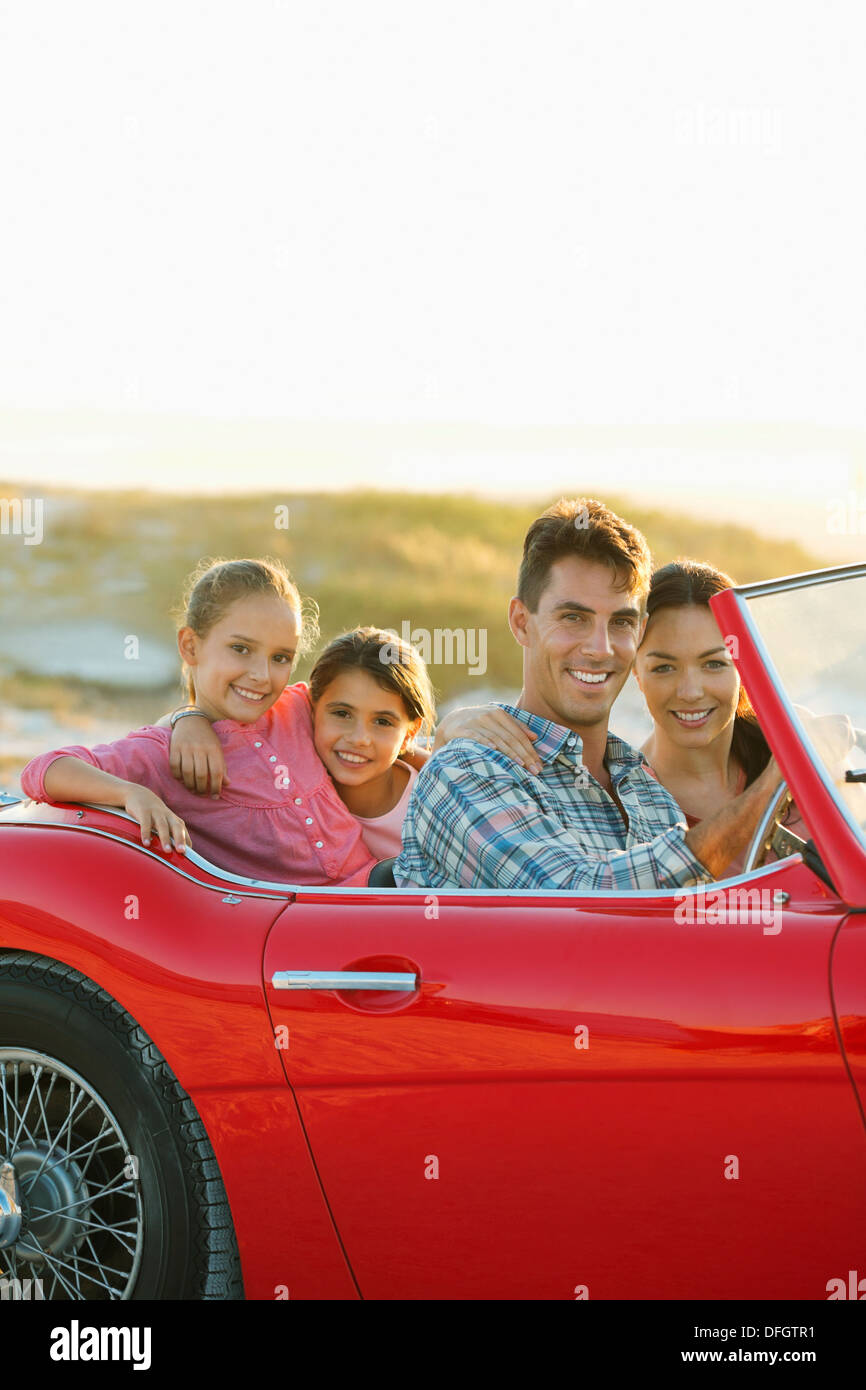 Family driving together in convertible Stock Photo - Alamy