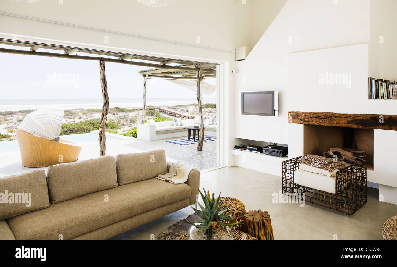 Modern living room overlooking ocean Stock Photo - Alamy