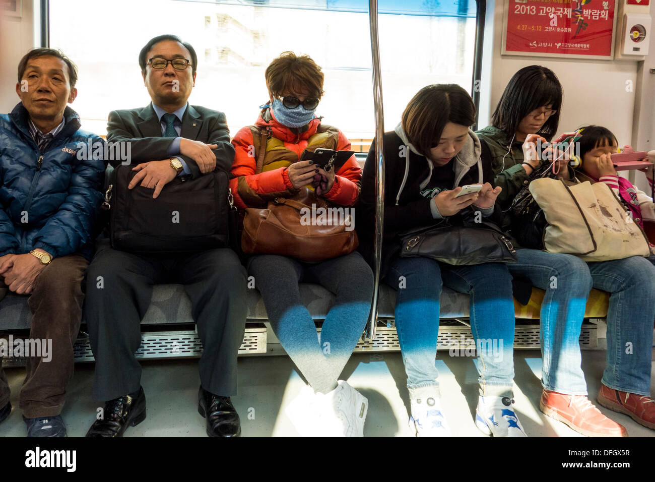 Passengers using mobile phones on subway train, Seoul, Korea Stock ...