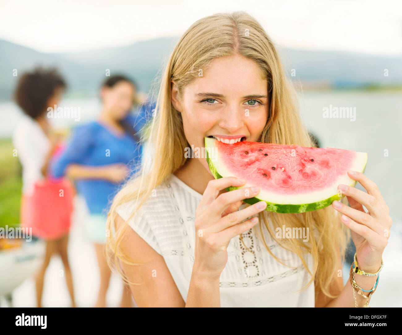 Portrait of woman eating watermelon outdoors Stock Photo - Alamy