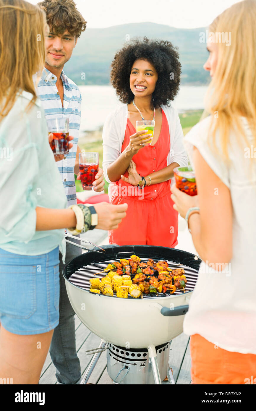 Friends talking at barbecue Stock Photo - Alamy
