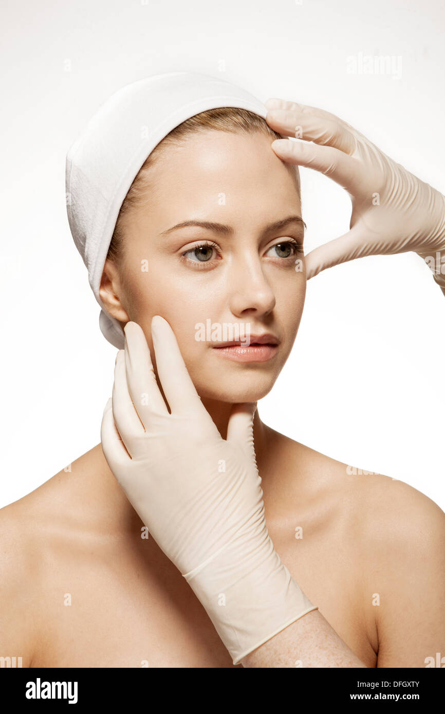 Doctor examining woman's face Stock Photo - Alamy