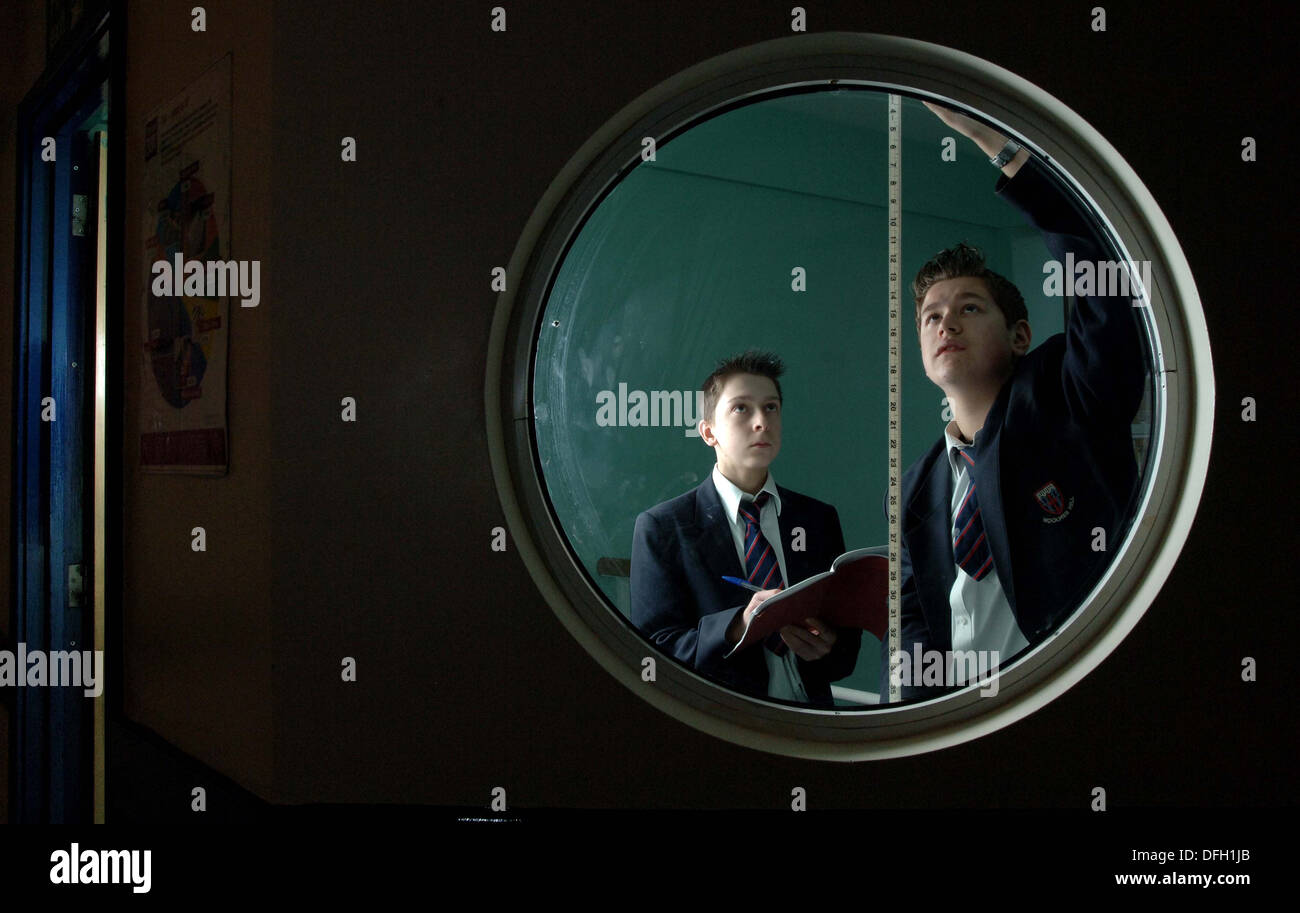 pupils using tape measure in classroom activity Stock Photo - Alamy