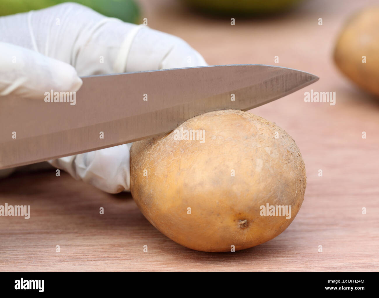 Cutting potato with a kitchen knife Stock Photo - Alamy