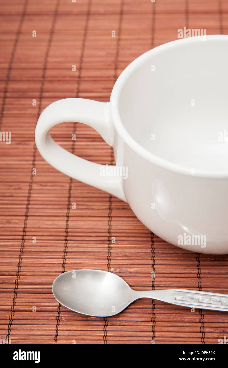 Coffee cup and spoon on a wood background Stock Photo - Alamy
