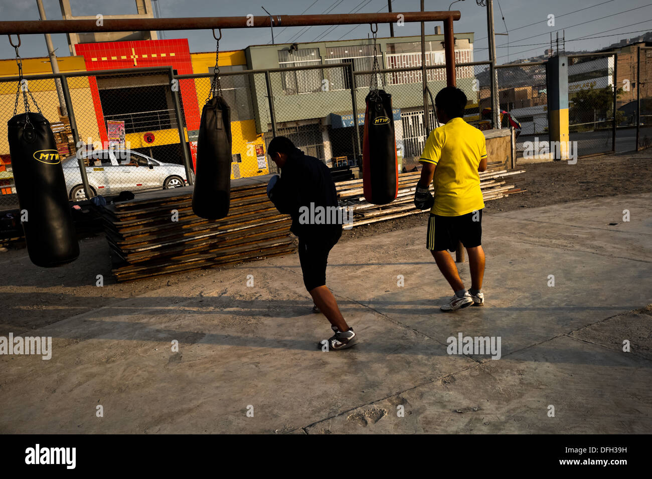 Peruvian youths train with punching bags at the Boxeo VMT boxing club ...