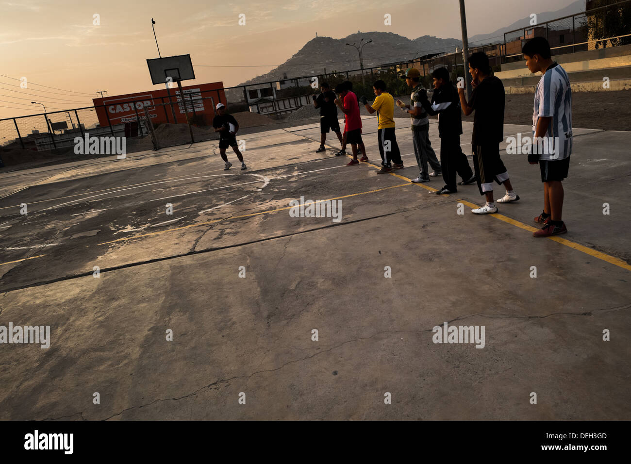 Peruvian youths exercise with a coach at the Boxeo VMT boxing club in ...