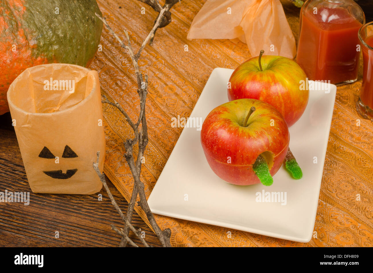 Halloween dessert for children, rotten apples with candy worms Stock ...