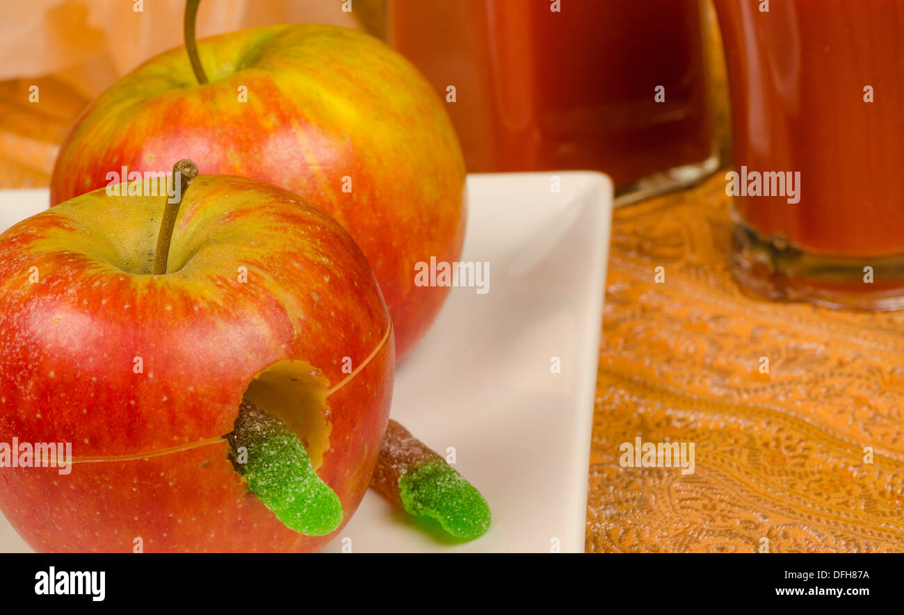 Halloween dessert for children, rotten apples with candy worms Stock ...