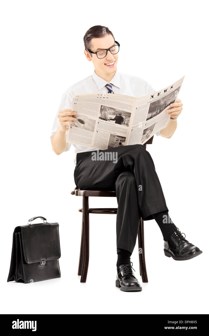 Man sitting on a chair reading a newspaper hi-res stock photography and ...