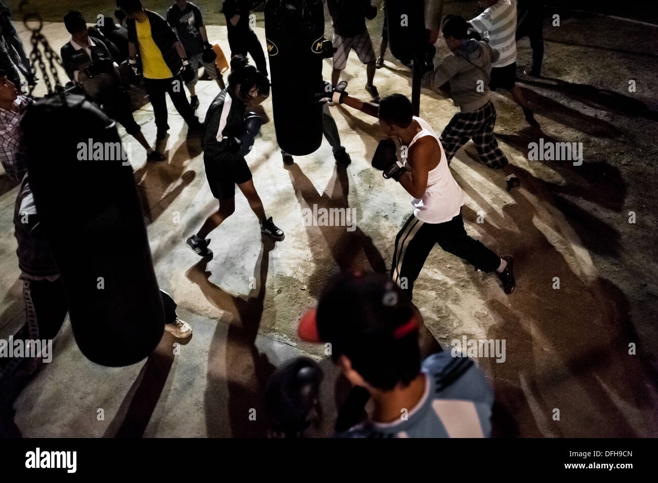 Peruvian youths practice with punching bags during the evening at the ...