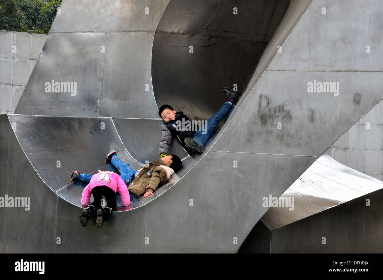 Chinese kids play in outdoor metal sculpture, Shanghai China Stock ...