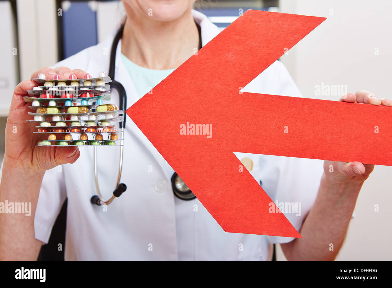 Hand holding red arrow caution against drugs in doctors office Stock ...