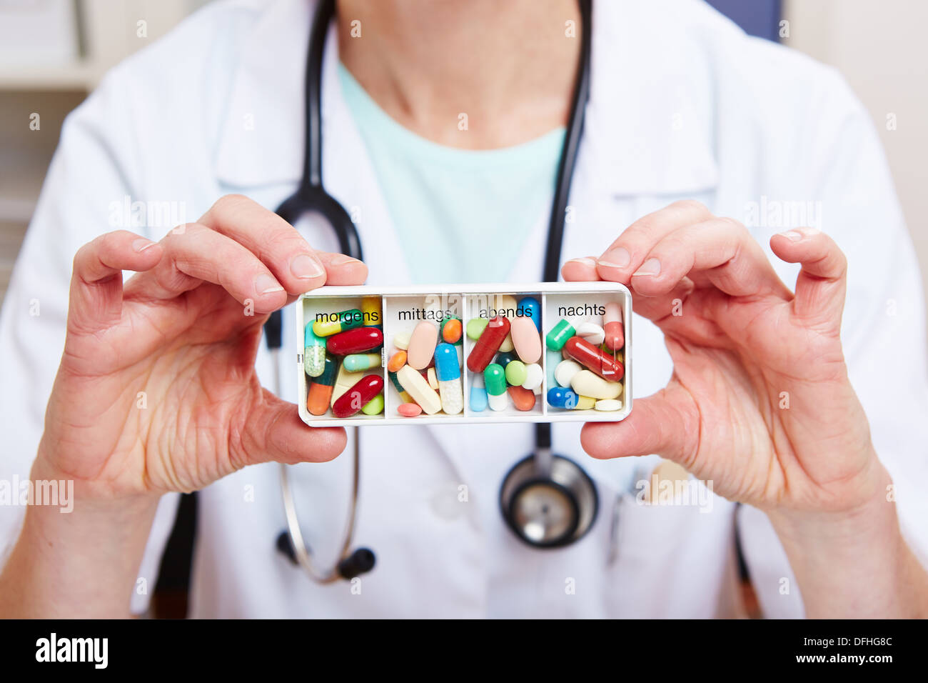 Doctor hands holding many colorful tablets in pill box Stock Photo - Alamy