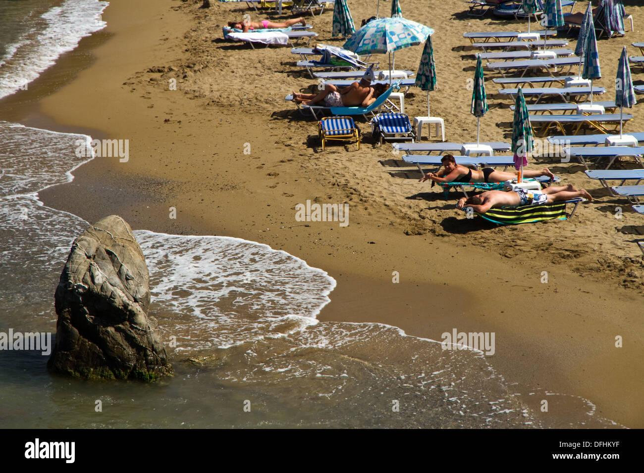 Sunbathing at Panormos Beach, Crete, Greece Stock Photo - Alamy