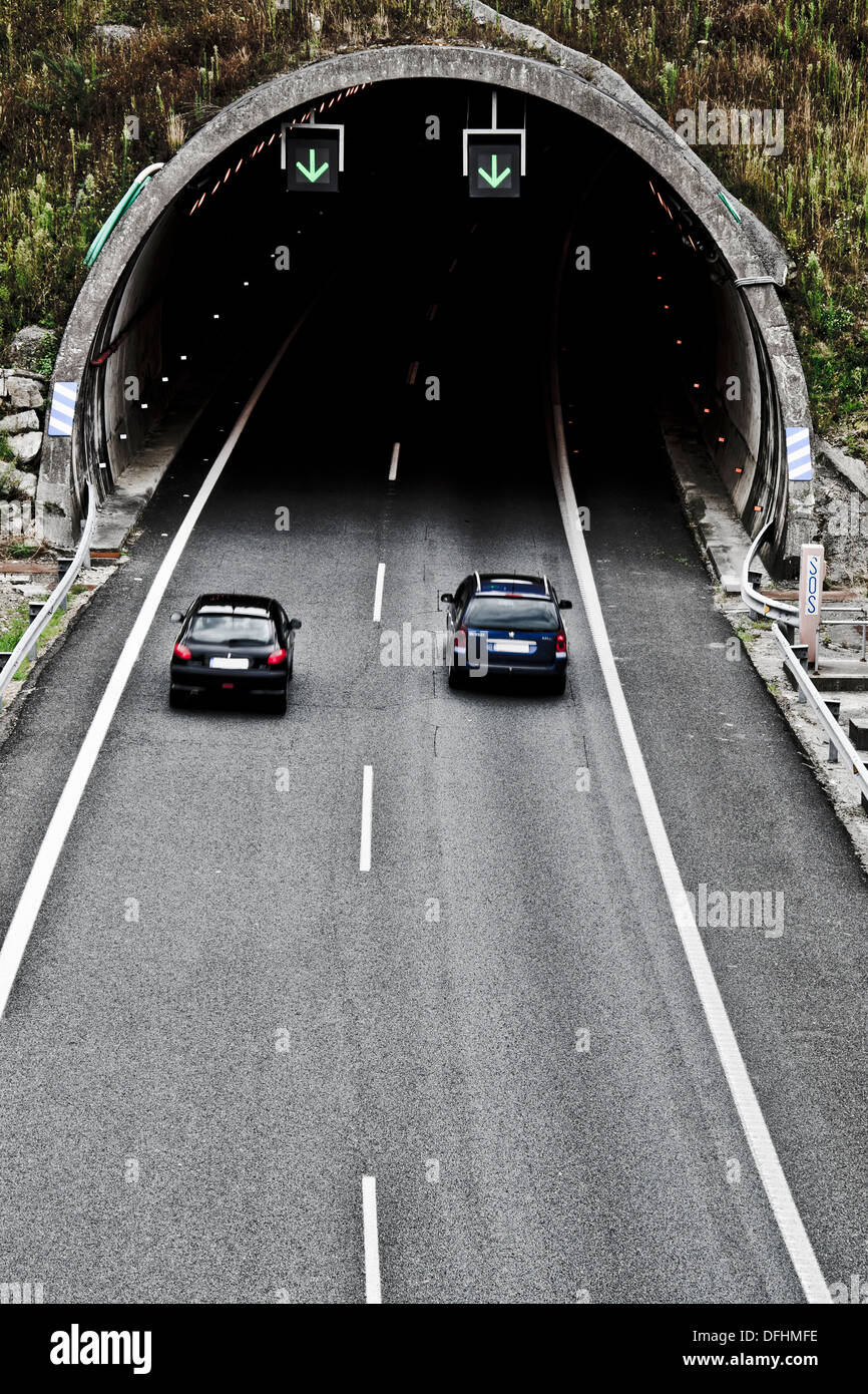two cars entering the highway tunnel, Spain Stock Photo - Alamy