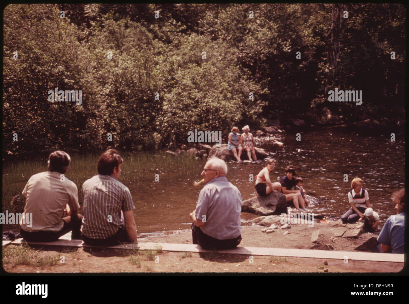 A group of Canadians gathers by Cascade Pond, a popular picnic area ...
