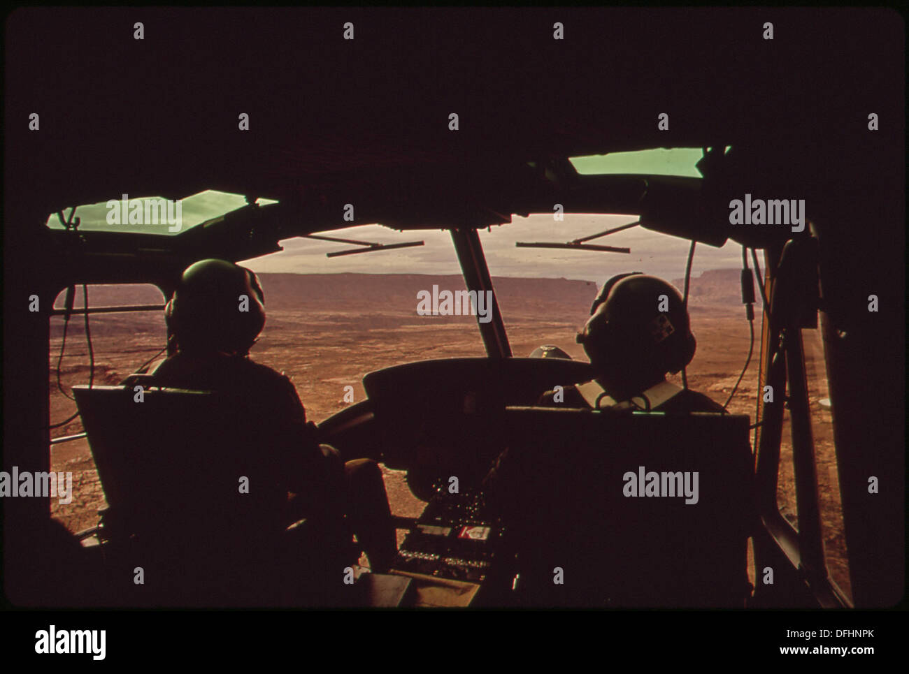 A helicopter lands near a log boom in Monument Valley, Utah, as part of ...
