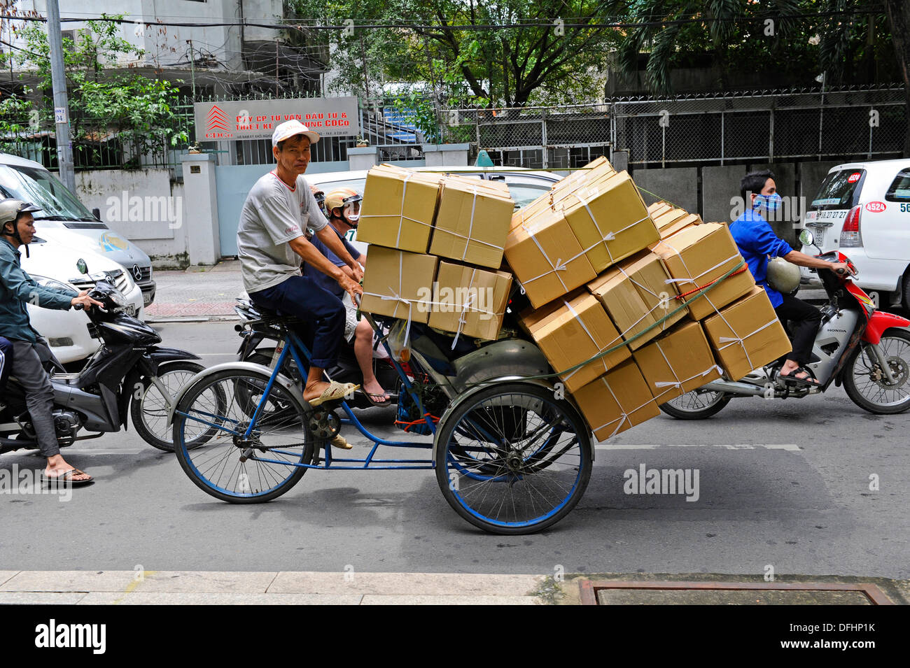 Over loaded tri-cycles with large boxes being cycled on the busy ...