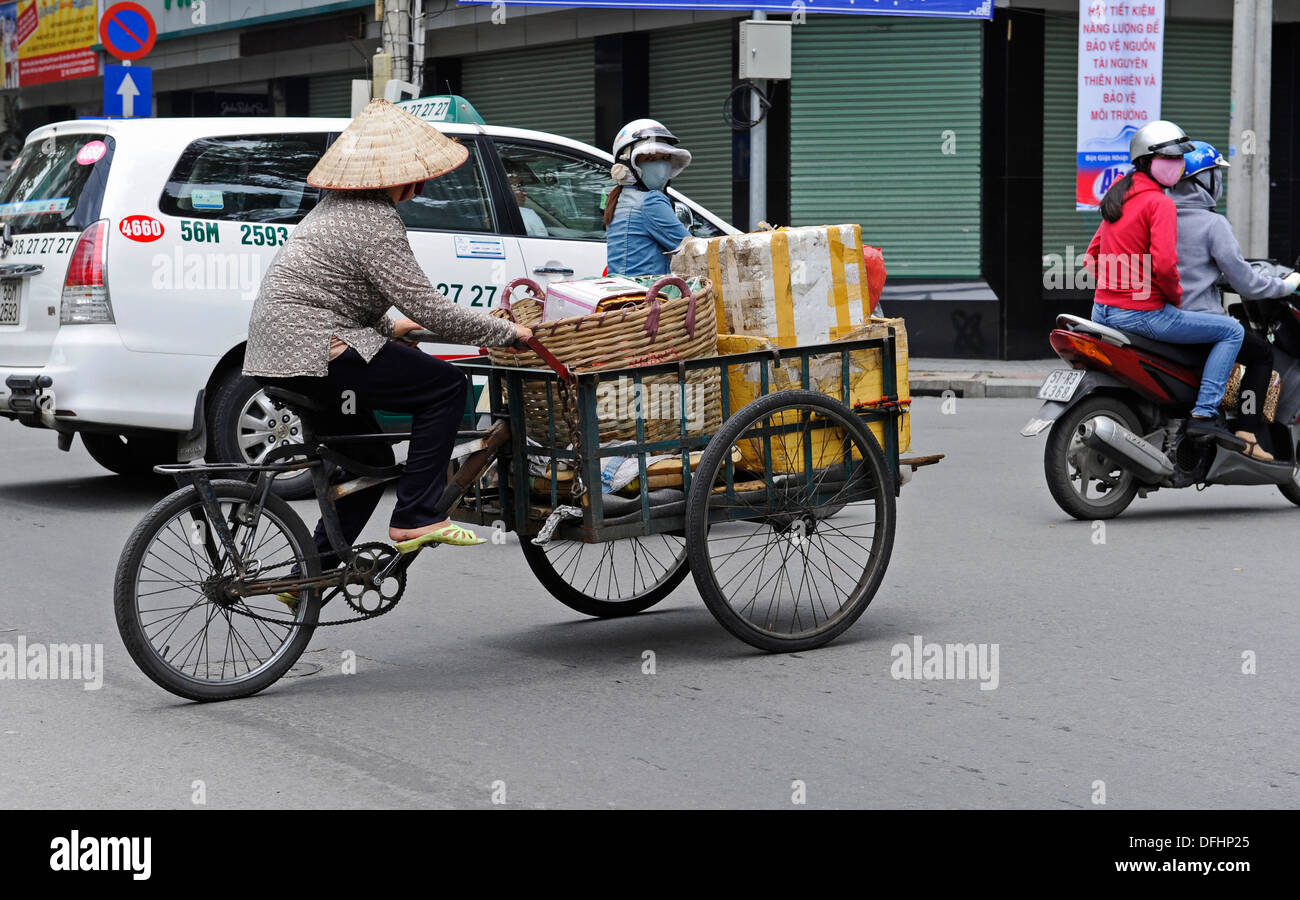 Over loaded tri-cycles with large boxes being cycled on the busy ...