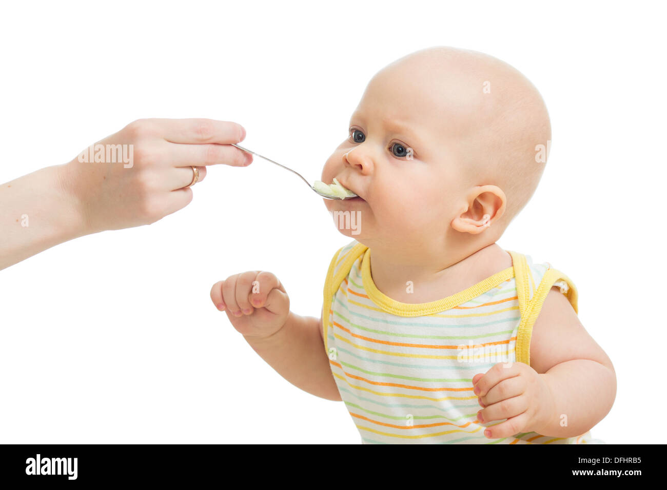 Mother's hand feeding baby with a spoon Stock Photo - Alamy