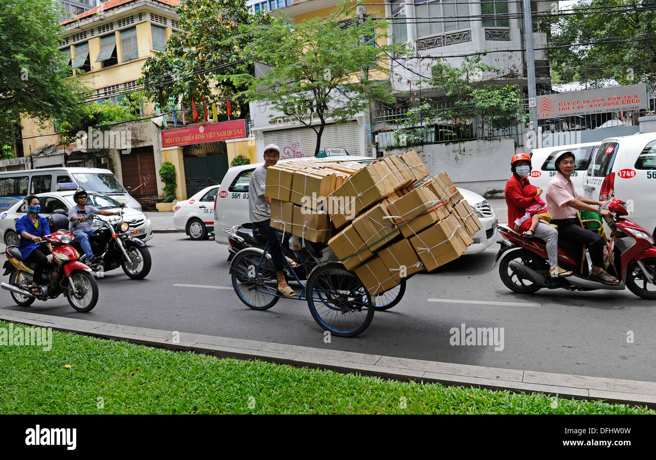 Over loaded tri-cycles with large boxes being cycled on the busy ...