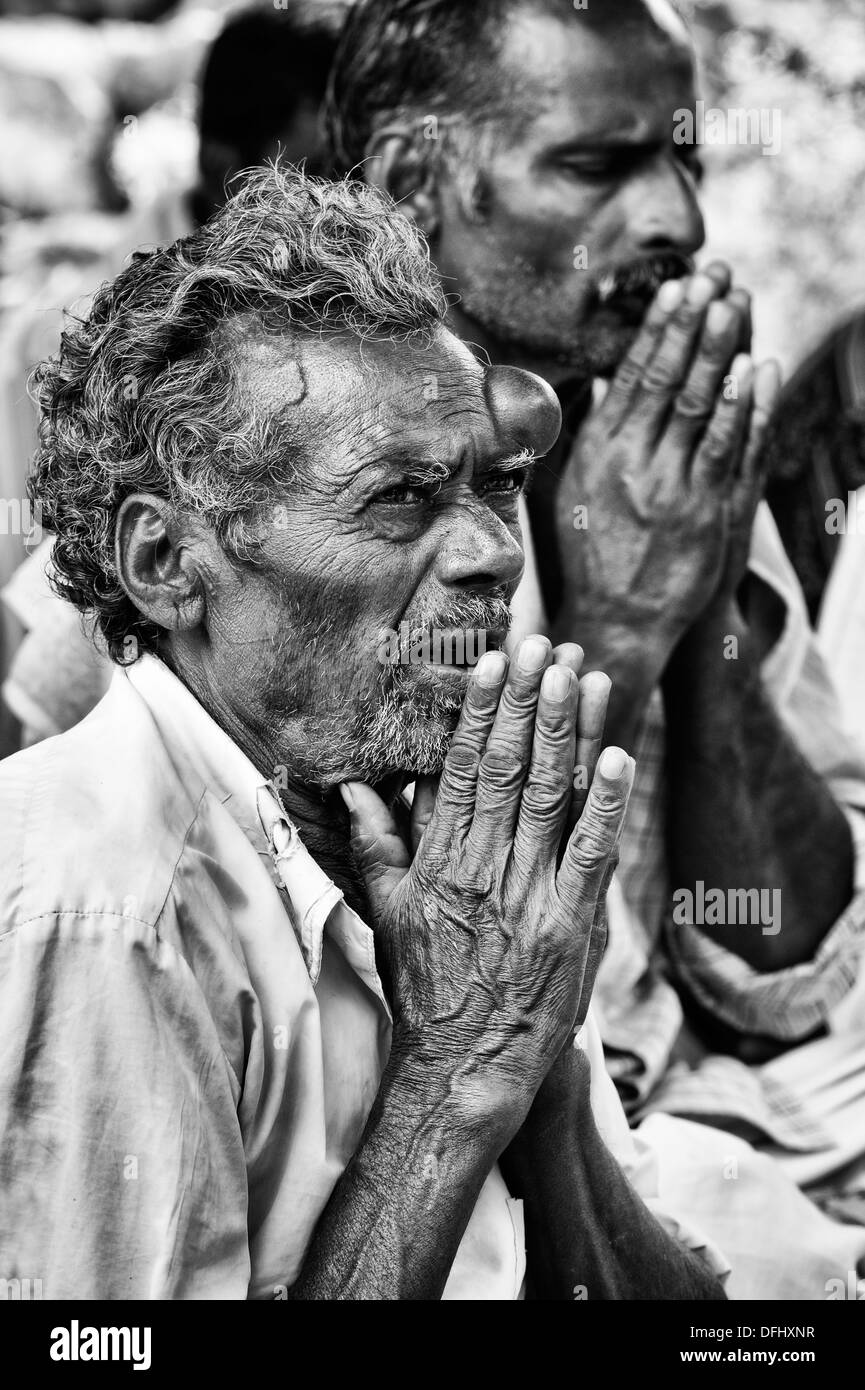Indian man praying in traditional Black and White Stock Photos & Images ...