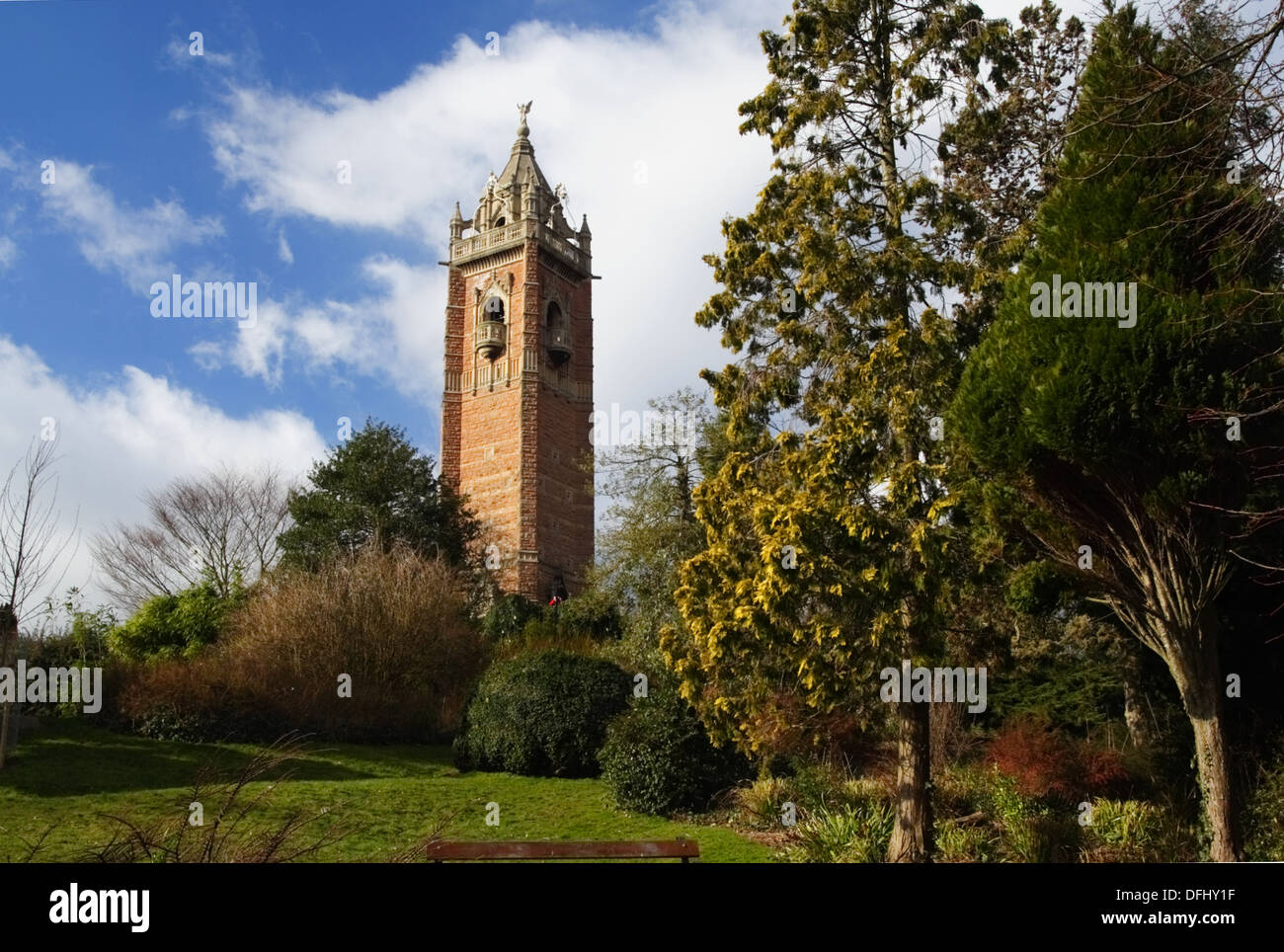 A Gothic red brick tower with a group of trees in a park Stock Photo ...