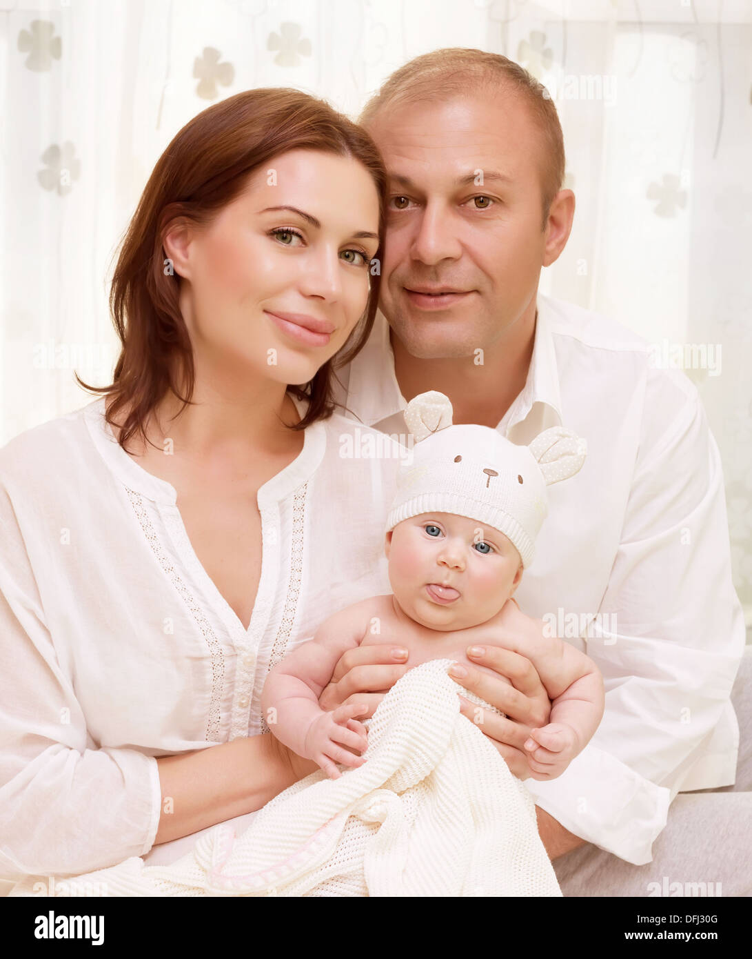 Closeup portrait of parents with newborn baby at home, little child ...
