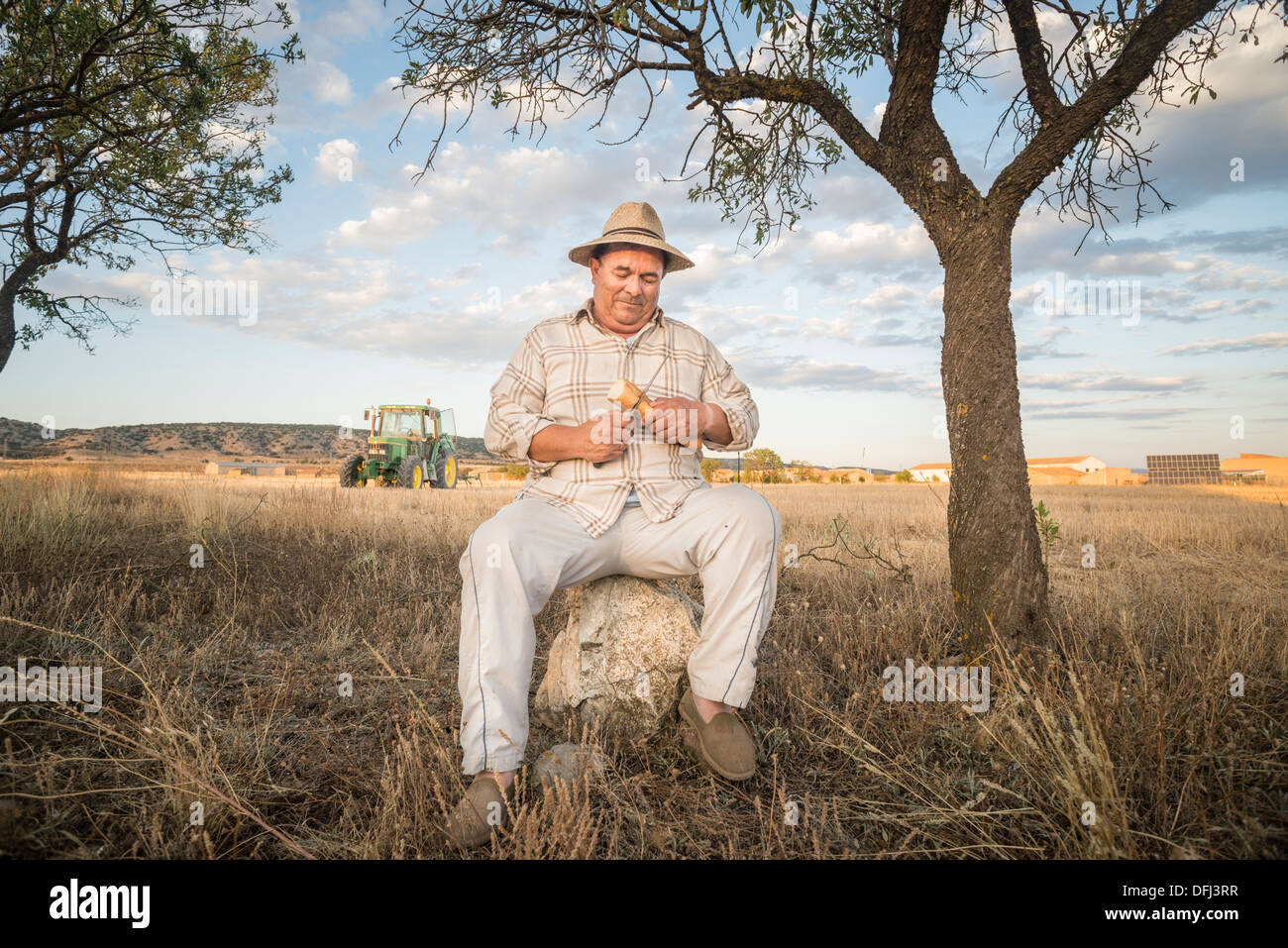 Farmer resting after work in his farmland Stock Photo - Alamy