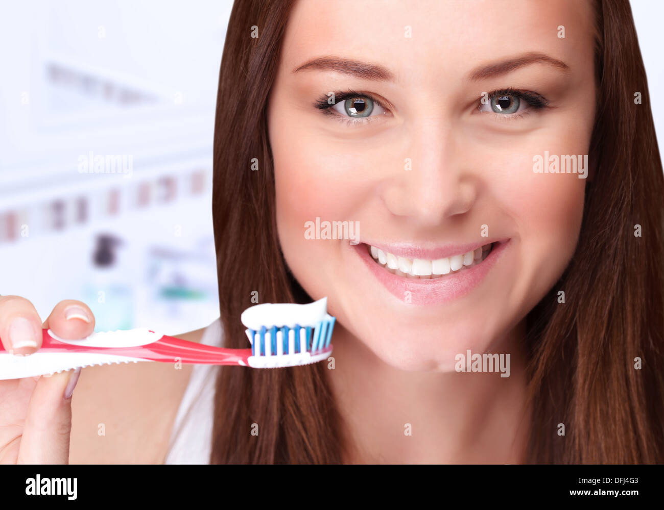 Closeup portrait of attractive female clean teeth in the bathroom ...