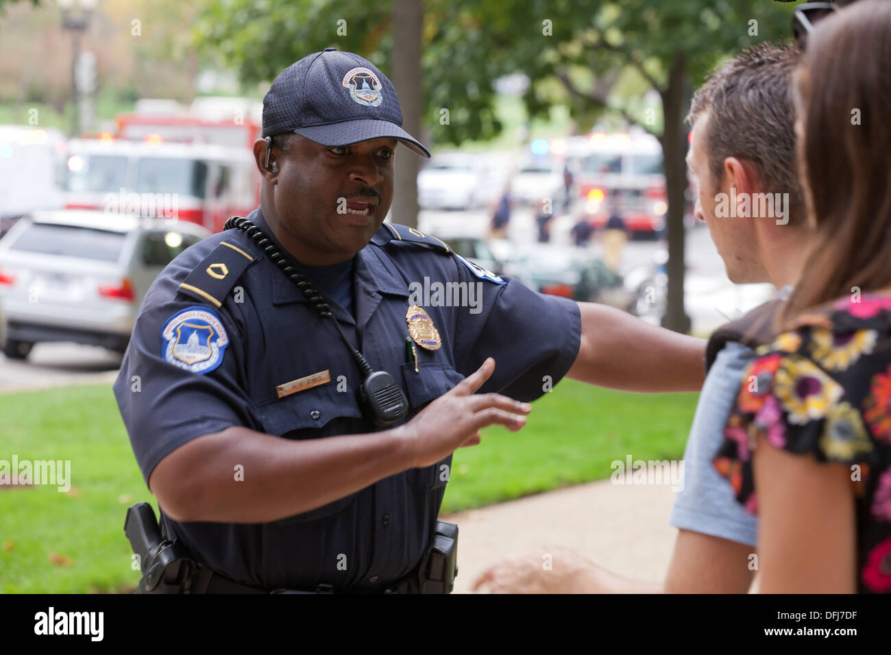 Policeman pushing back crowd at crime scene - Washington, DC USA Stock ...
