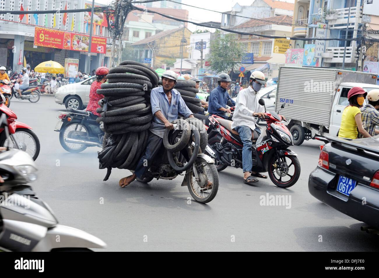 A man carry pile of tires on autobike in Ho Chi Minh City, Vietnam ...