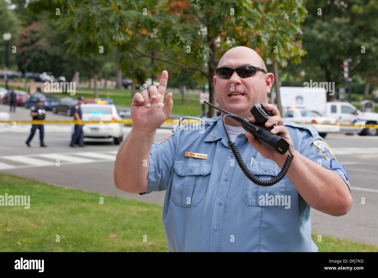 Policeman pushing back crowd at crime scene - Washington, DC USA Stock ...