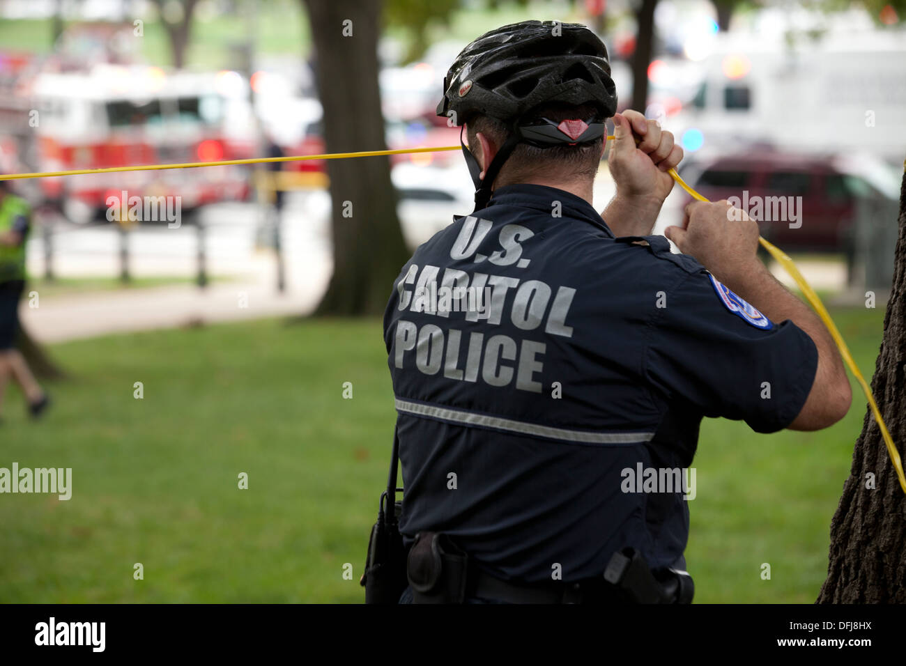 US Capitol Policeman putting up police line tape at a crime scene ...