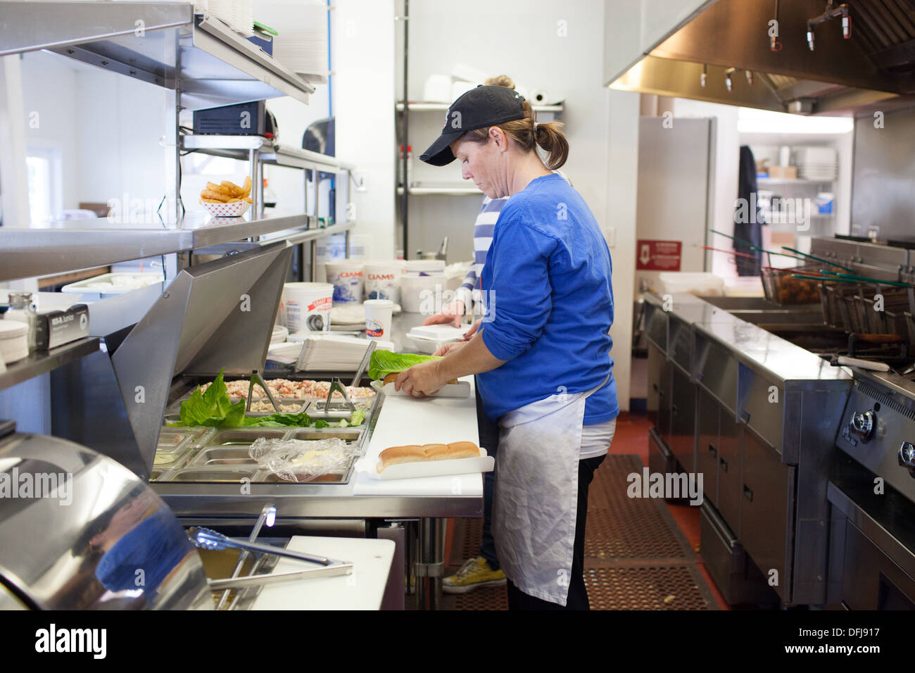 Susan Tierney prepares a lobster roll inside the kitchen at Captain ...