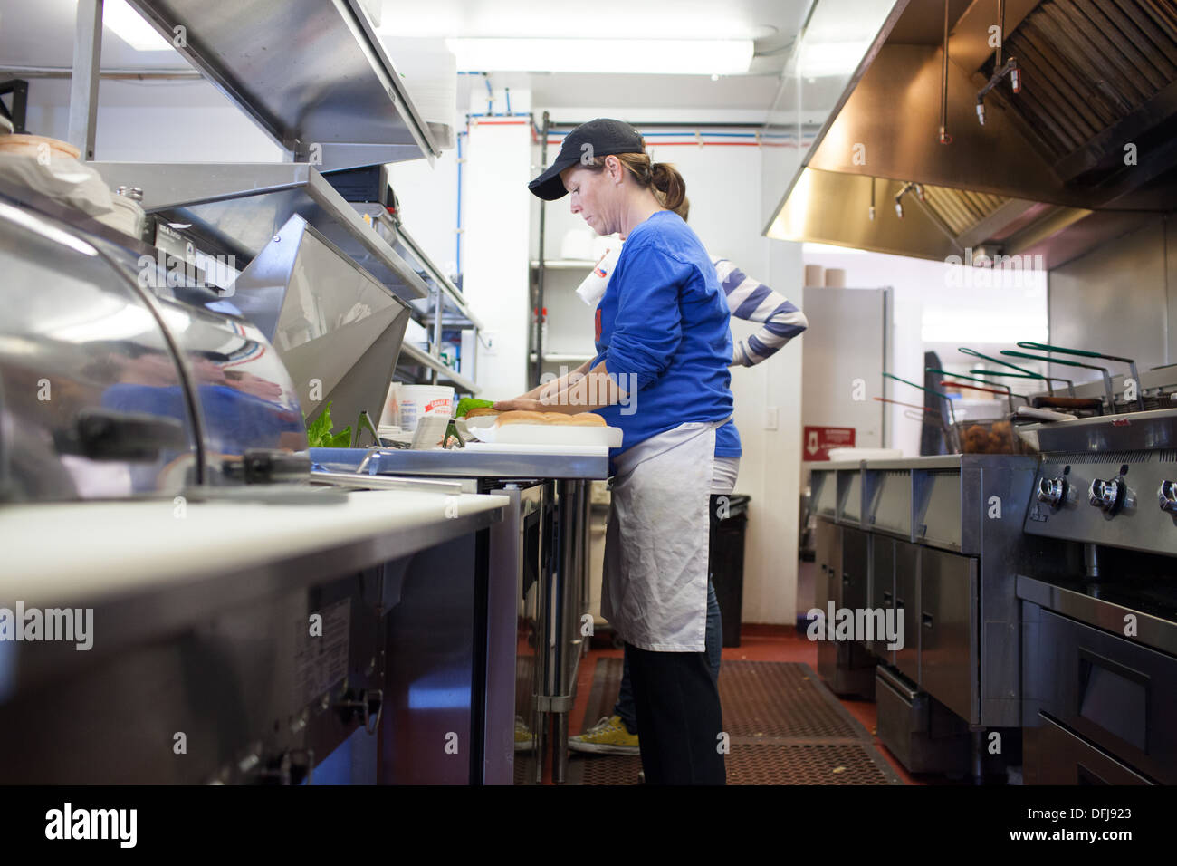 Susan Tierney prepares a lobster roll inside the kitchen at Captain ...
