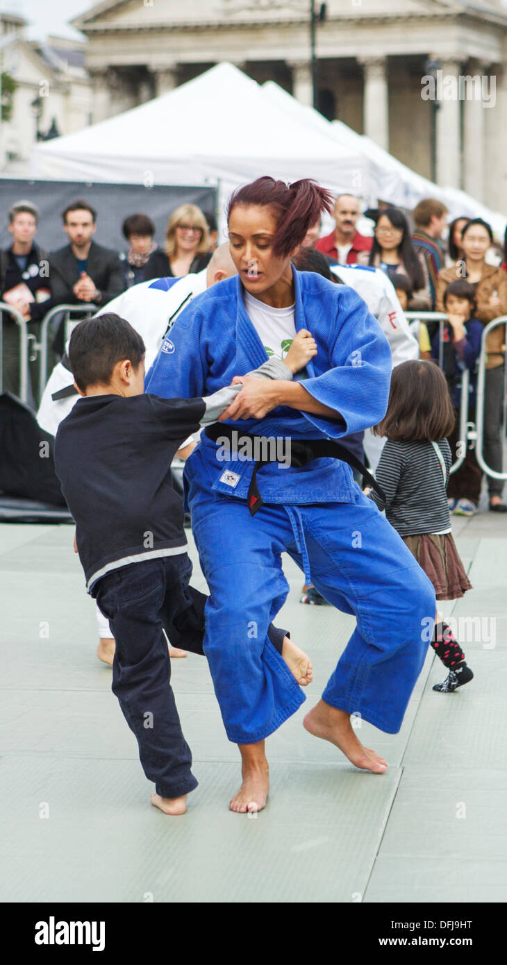 Young child children doing judo with adult Stock Photo - Alamy