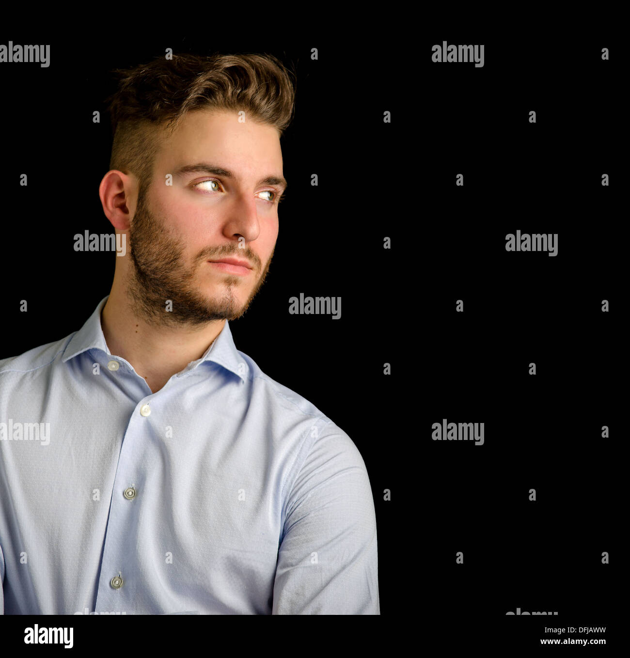 Handsome young man looking to a side, large copy-space, isolated on ...