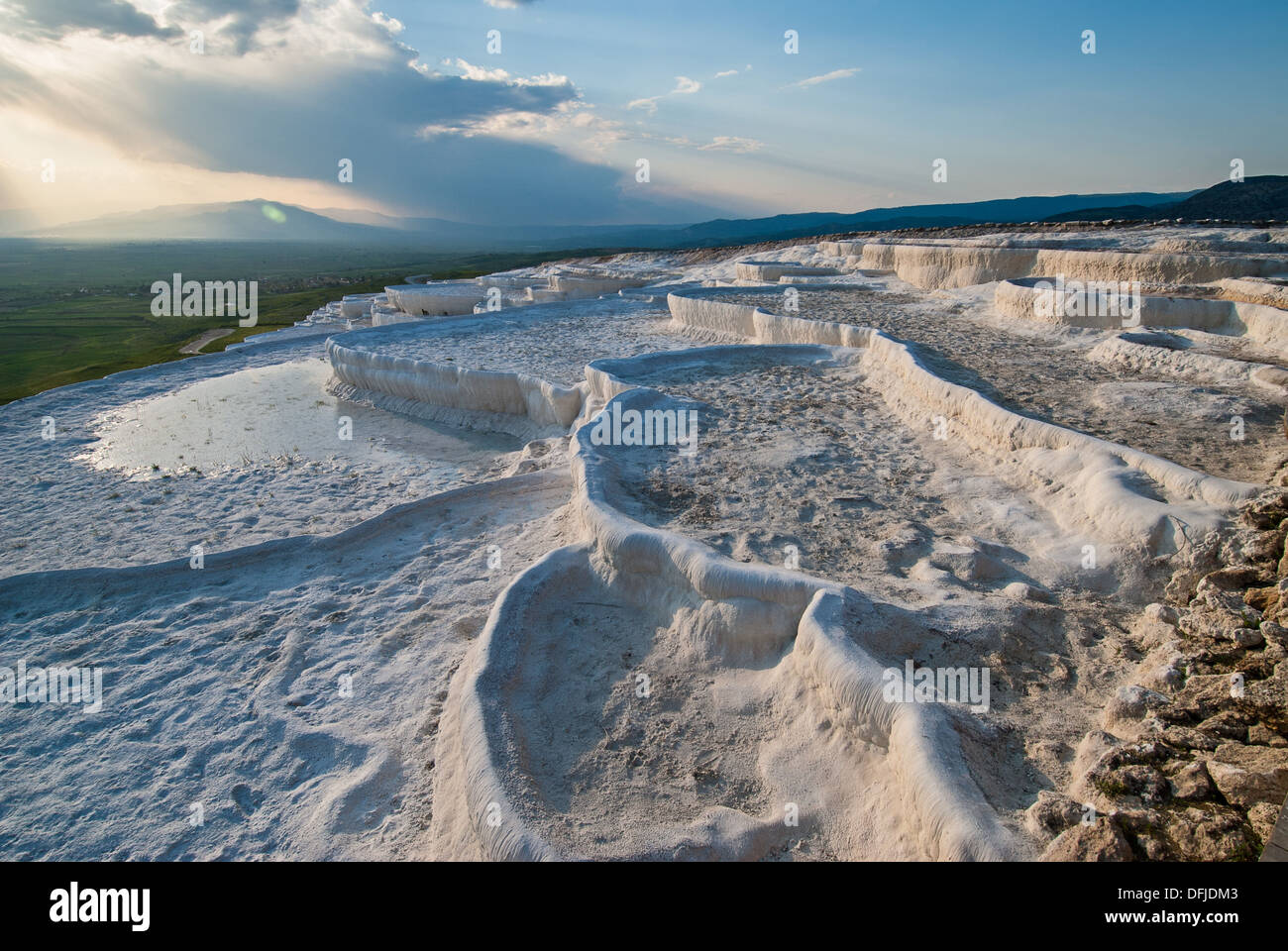 Natural travertine pools and terraces at sunset in Pamukkale, Turkey ...