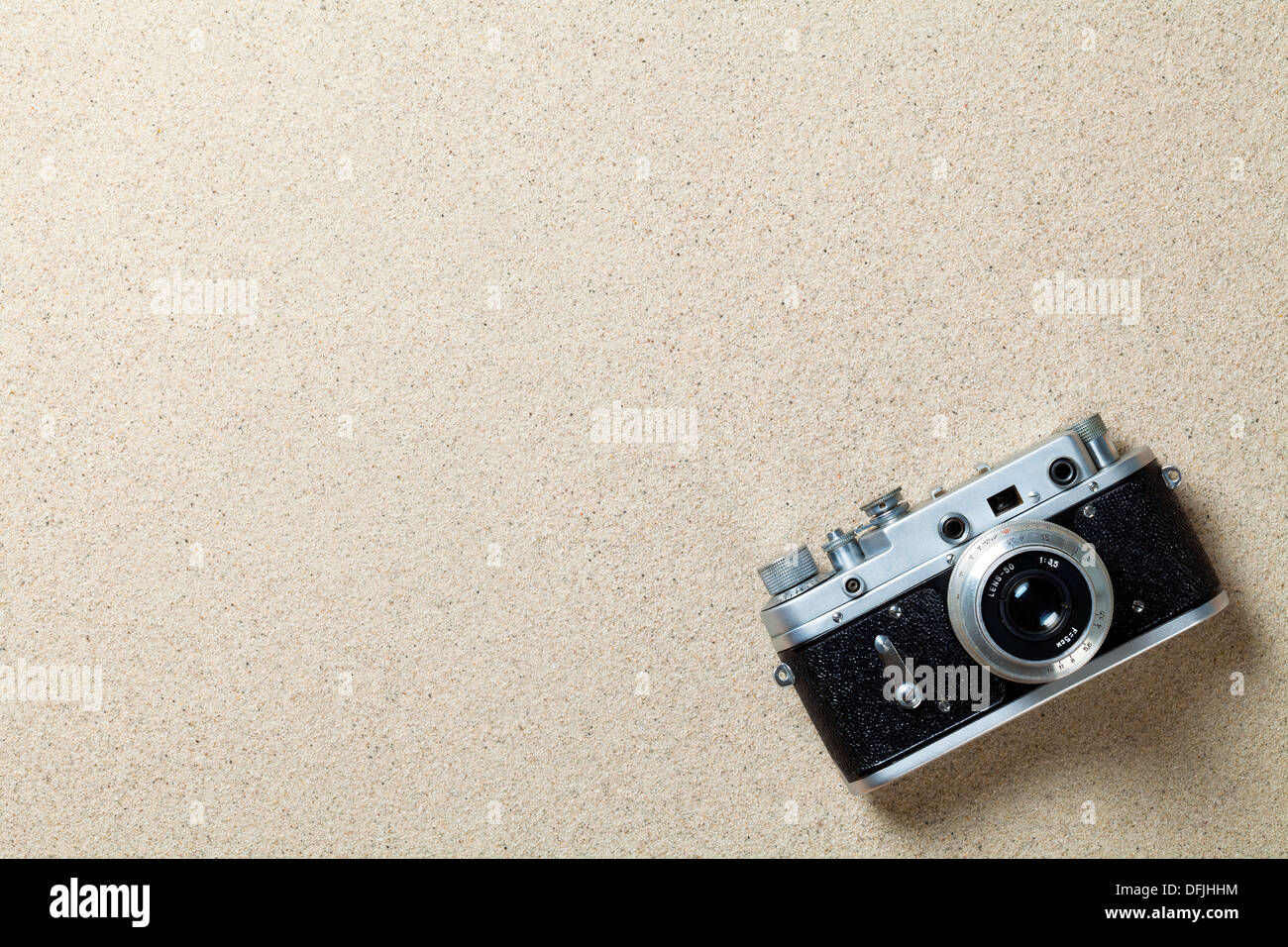 Sand texture with old retro camera. Sandy beach concept for background ...