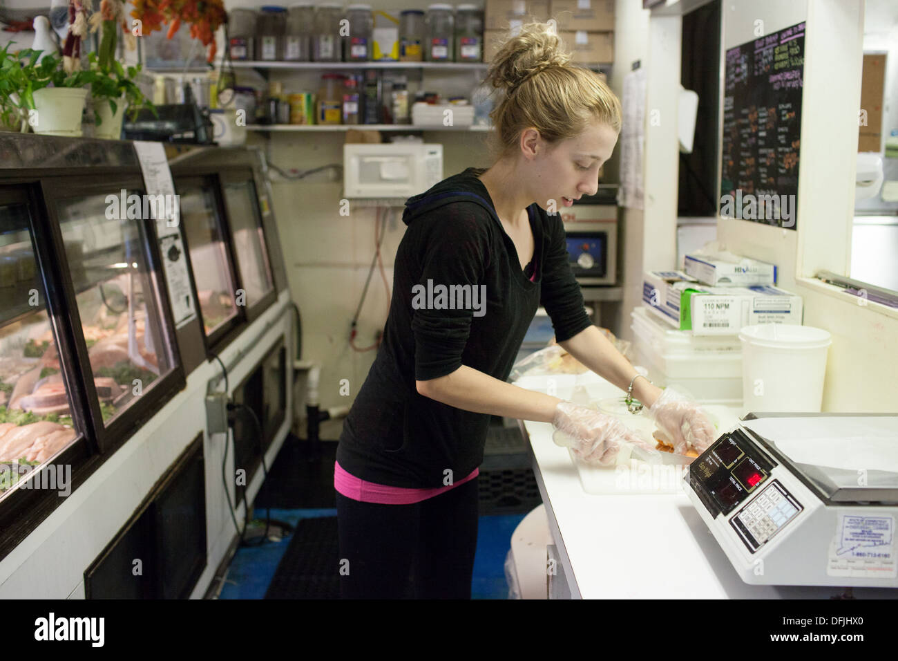Shelby Smith weighing the lobster and preparing a lobster roll in a ...