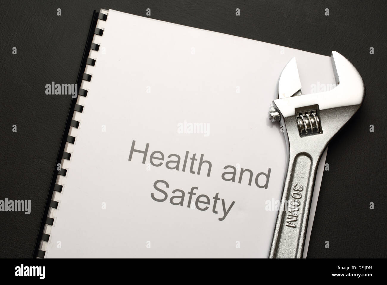 Health and safety register with spanner Stock Photo - Alamy