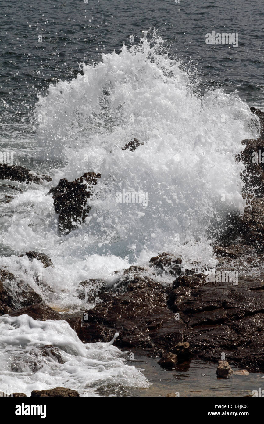 waves crashing against the rocks, in sunshine Stock Photo - Alamy
