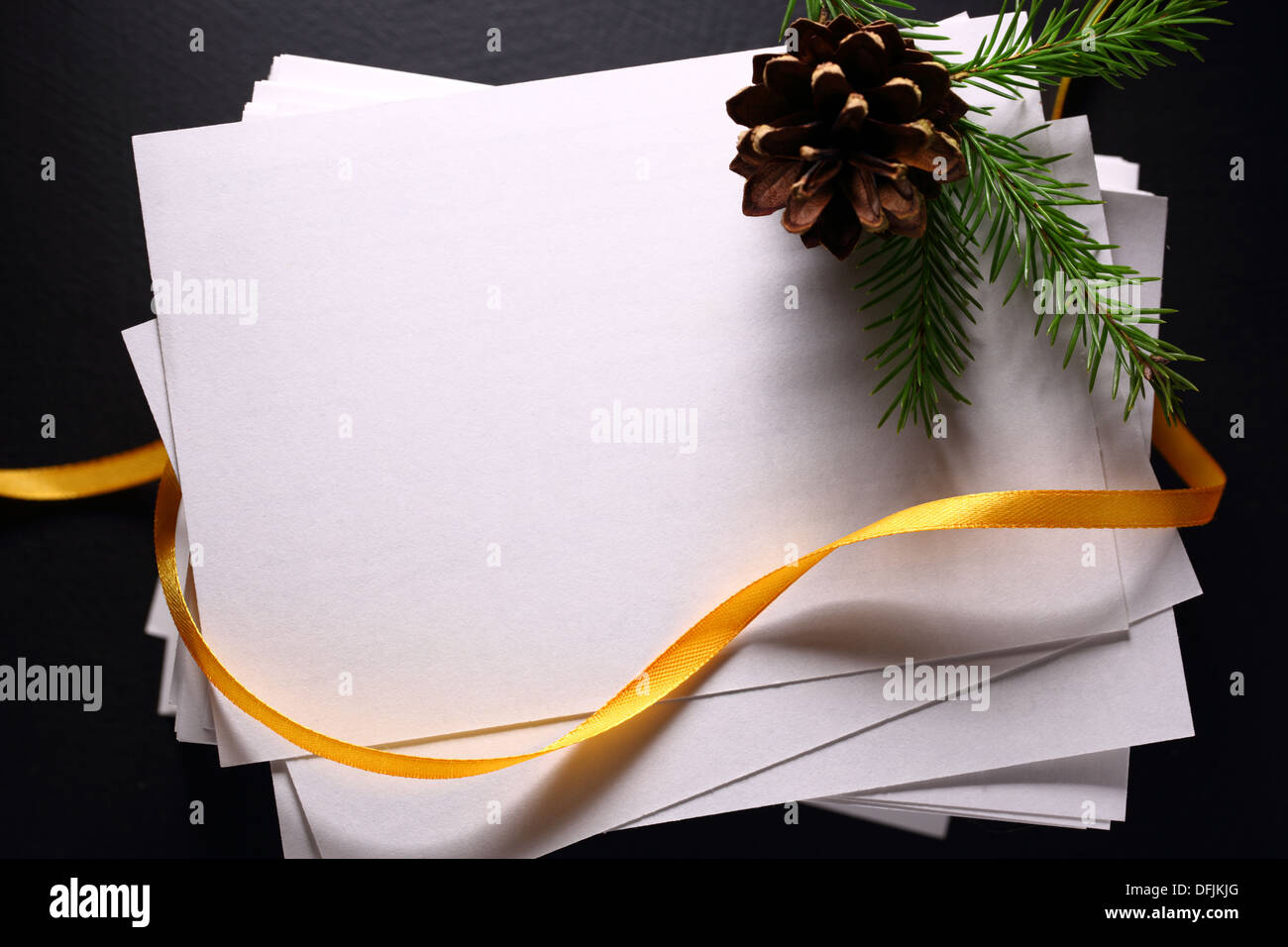 Stack of paper cards and twig of evergreen fir Stock Photo - Alamy