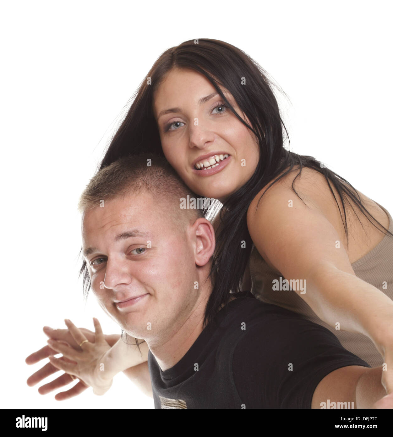 Cheerful couple having fun piggyback riding young smiling people ...